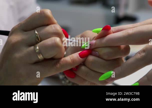 Professional manicure. Nail extension. Applying an artistic pattern to ...