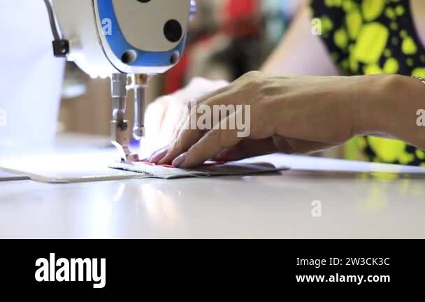 A professional seamstress at work in his workshop. She crafts her work ...