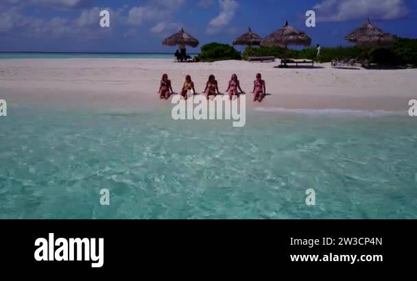video the tan girls in bikini lying on the white sandy beach and ...