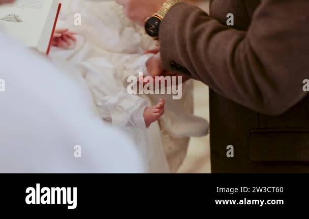 The priest reads the prayer in the church. The rite of baptism in the ...