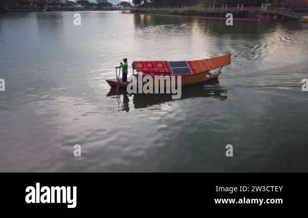 cinematic shot of boats carrying passenger across sarawak river in ...