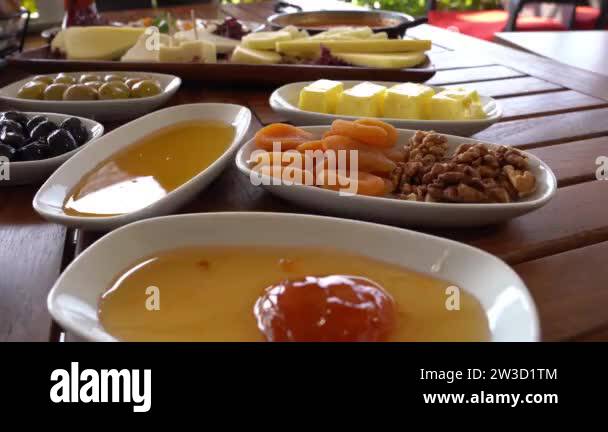 Turkish breakfast set of dishes on a table in a beautiful layout. Video ...