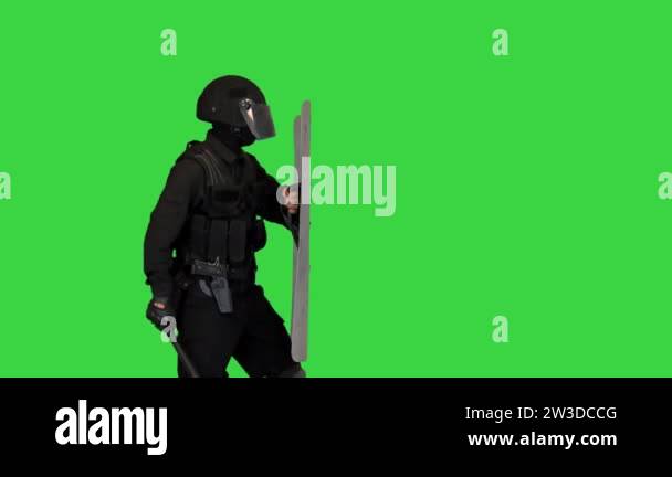 Riot police officer hitting his riot shield while moving forward with ...