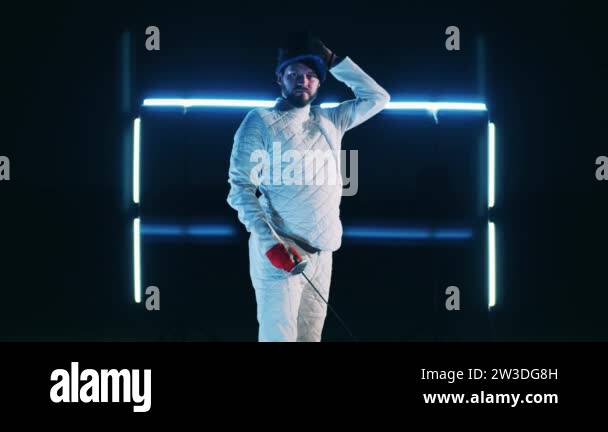 Male fencer is taking up a position to start practicing. Active athlete ...