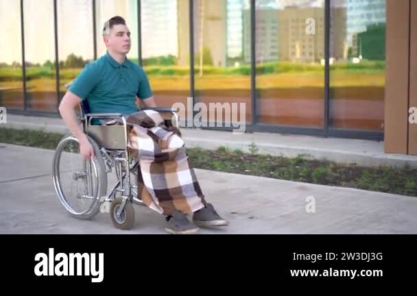A young man rides a wheelchair and a heart attack occurs. A man in a ...