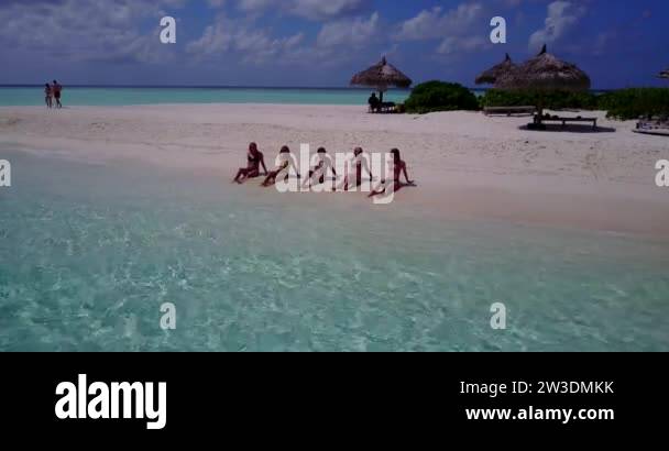 video the tan girls in bikini lying in a row on the white sandy beach ...