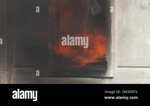 Close up of window of an apartment building from which smoke comes out ...