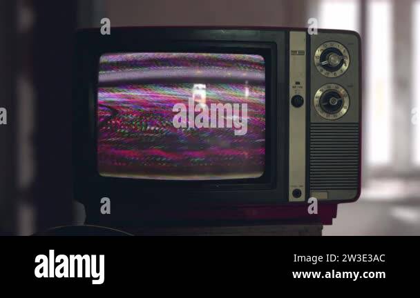 No signal old tube vintage TV set with static color noise in empty room ...