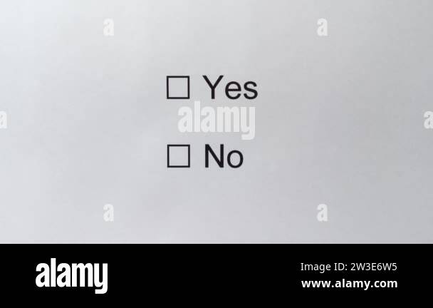 YES NO Man hand draw a tick in Yes checkbox on white paper with pen ...