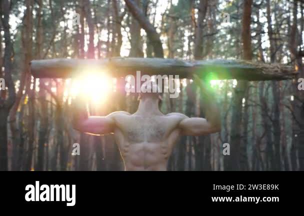 Muscular man lifting hard weight over head training hands. Strong guy ...