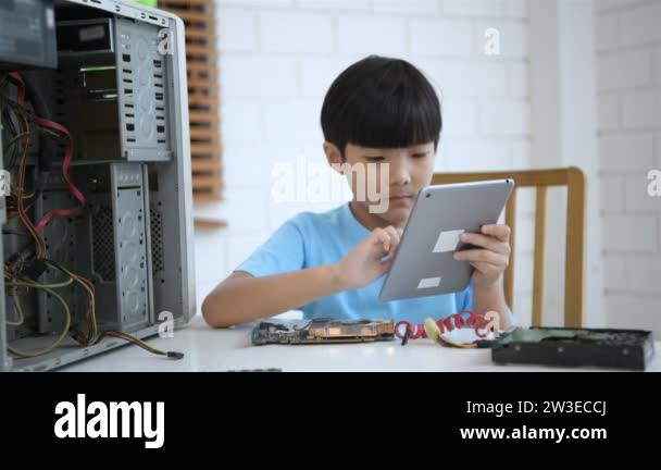 Learning concepts. The boy is learning to repair the computer in the ...