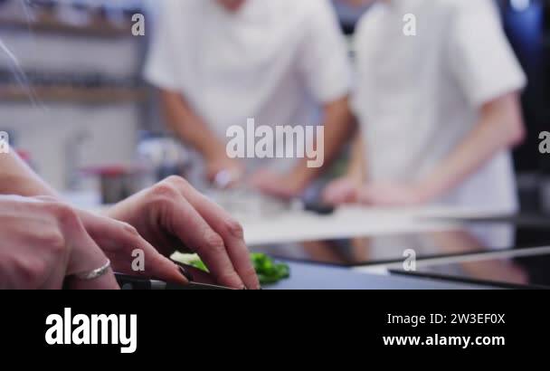 Professional Caucasian male chef wearing chefs whites in a restaurant ...