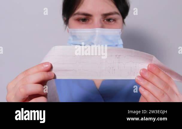 The Cardiologist Shows The Film Of An Electrocardiogram Of A Patient