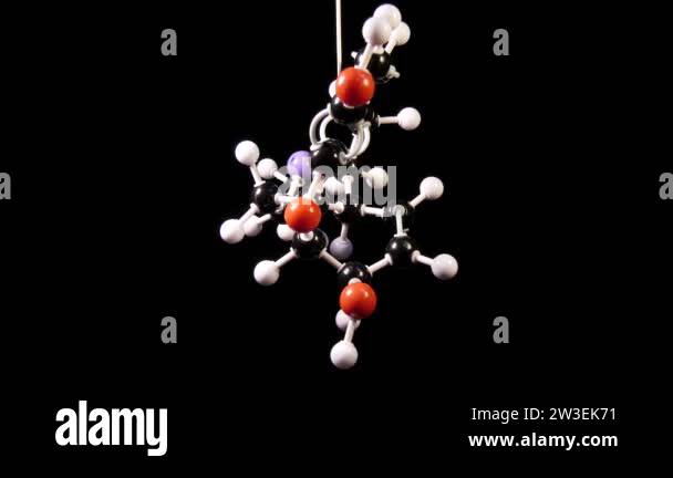 Chemical Formula of a molecule rotating isolated on a black background ...