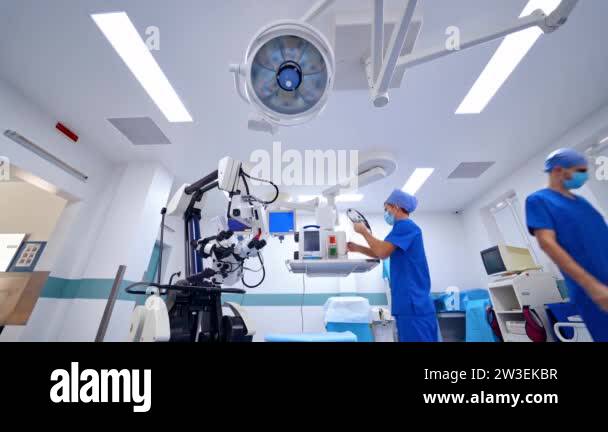 New robotic equipment in clinic. Doctors prepare medical instruments on ...
