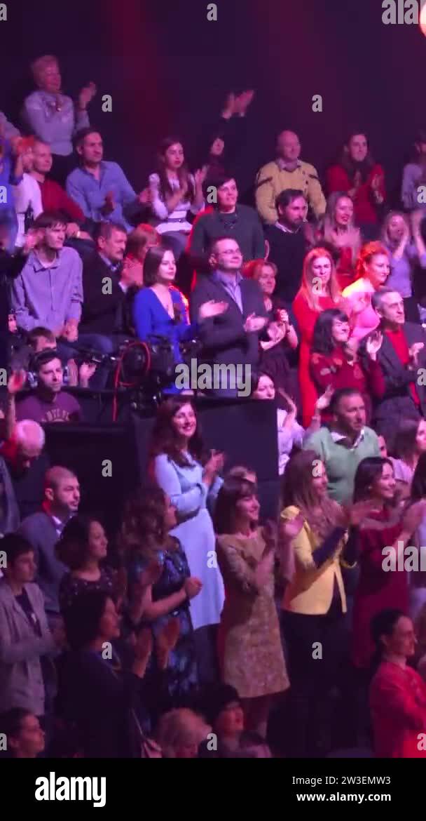 People viewers in a TV studio while recording a TV show. Vertical video ...