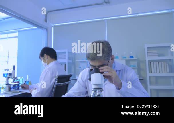 Research concept of 4k resolution. Asian scientists are examining the ...