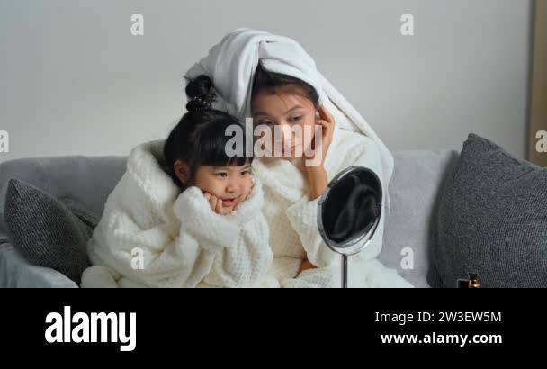 Couple of beauties young mother and little daughter asian family wear ...