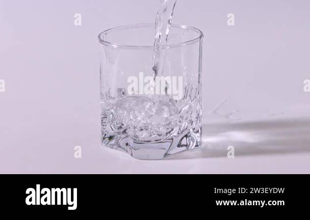 clear water is pouring into empty glass on white background Stock Video ...