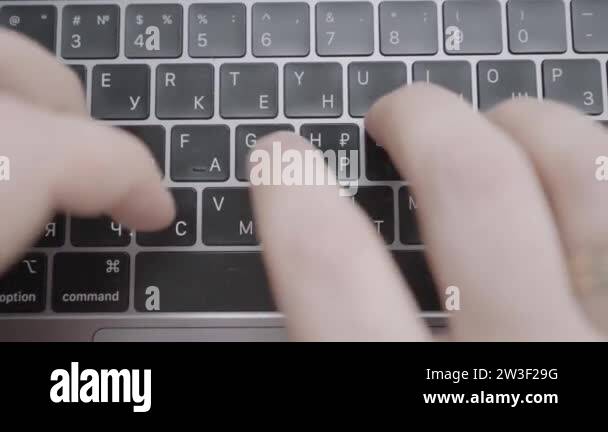 The man is texting quickly with his hands on a black keyboard with an ...