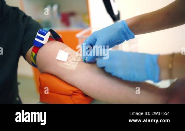 Nurse taking blood sample from vein. Close-up worker's hands in sterile ...