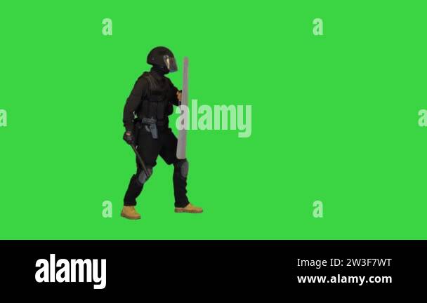 Riot police officer hitting his riot shield while moving forward with ...