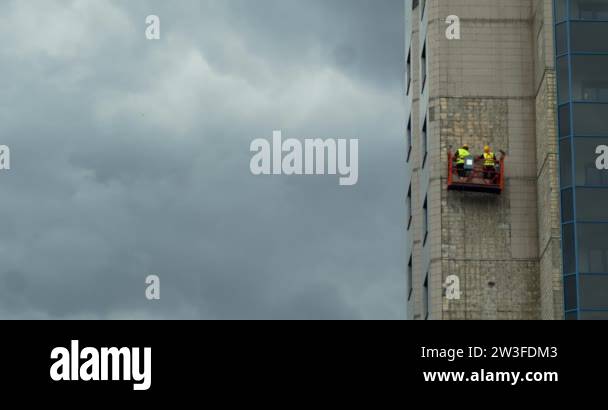 Team of windows cleaner outside the windows of sky scraper building ...