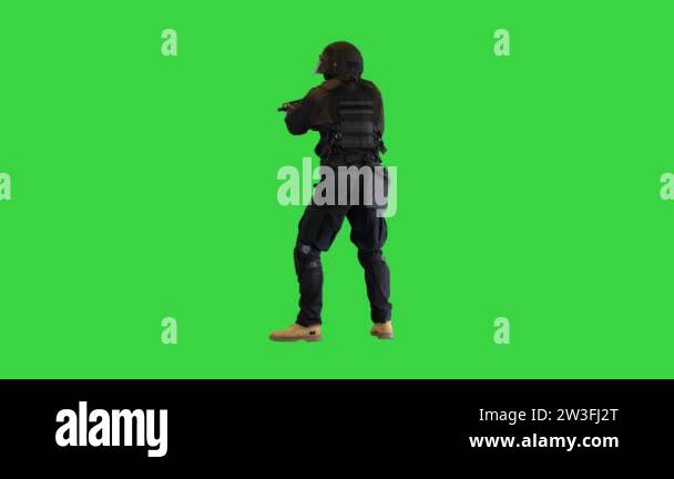 Police unit in black tactical suit searching for a target on a Green ...