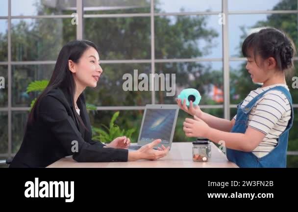Little girl is learning financial by making Bank deposit with her Piggy ...