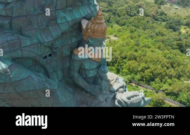 Close up aerial view of Vishnu riding Garuda. Giant copper blue and green Garuda Wisnu Kencana ...