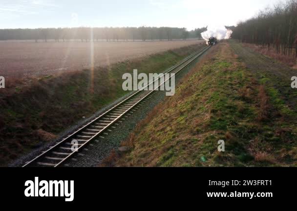 Steam train with white smoke on railroad. Vintage locomotive with old ...