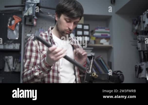 Electric scooter repair workshop. Mechanic holds in his hand broken ...