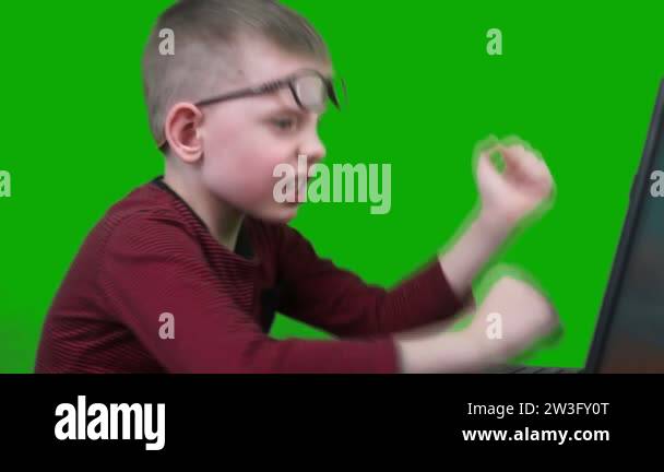 A 5-8 year old Caucasian boy with glasses angry swears at the monitor ...