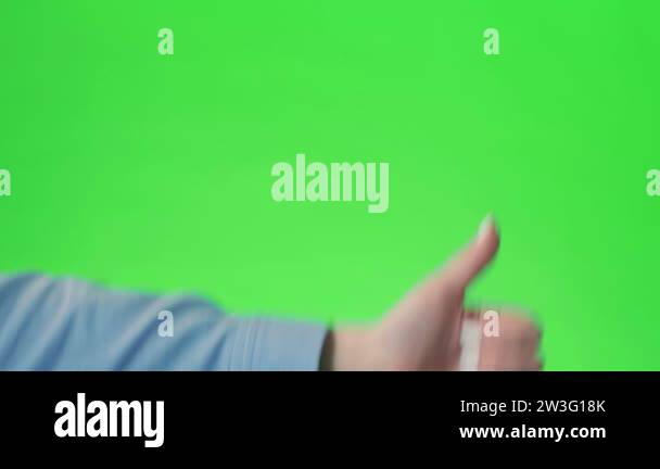 Thumbs up sign hand gesture on green screen. Simbol of approval like ...