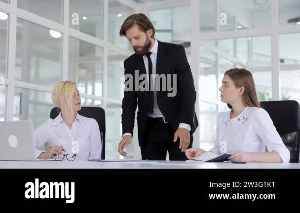 An angry boss enters the office scolds a female employee for a poor ...