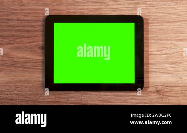 Top view on the man's hands using the white horizontal tablet device ...