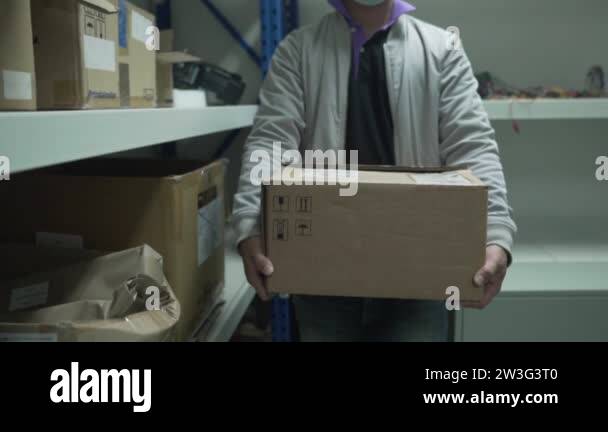 Footage Slow Motion: The parcel staff are holding the cargo box to the ...