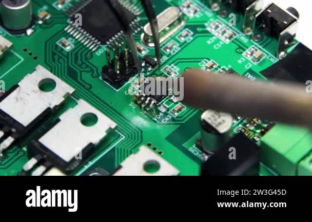technician repairing electronic of the computers circuit board by soldering Irons, concept ...