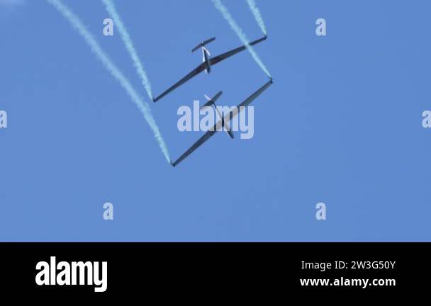Aerobatic gliders in mirror formation with one flying upside down over ...