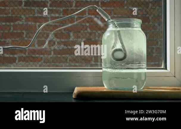 the process of boiling water in a glass jar by heating the boiler from ...