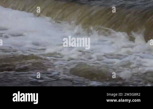 Industrial waterfall line Dam with foamy water flow close-up view on ...