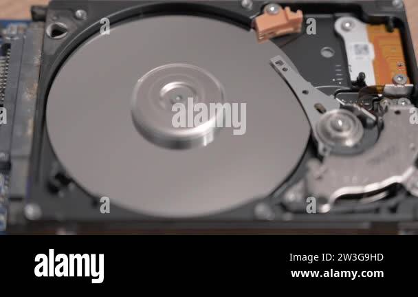 4k Close up video of the read and write head of a hard drive while it ...