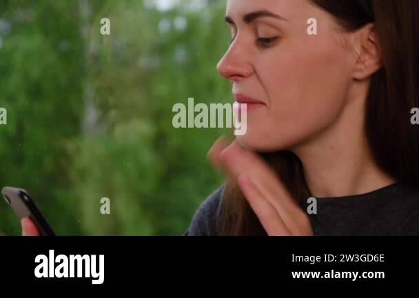 Close up of cheerful brunette woman making facetime video calling with ...