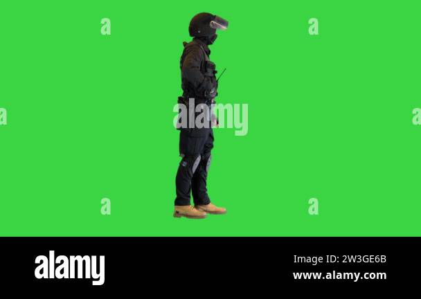 Police tactical officer checking his hand gun and folding hands on a ...