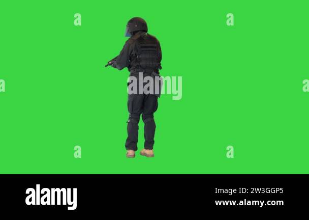 Police special forces officer holding position on a Green Screen ...