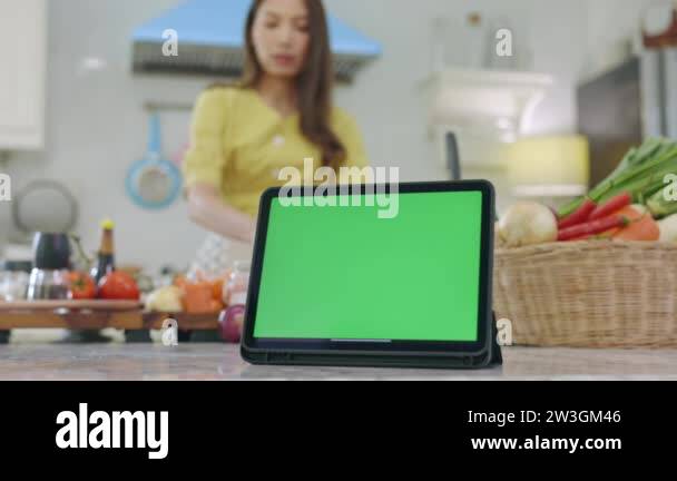 Tablet with a green screen With a beautiful background Cooking in the ...