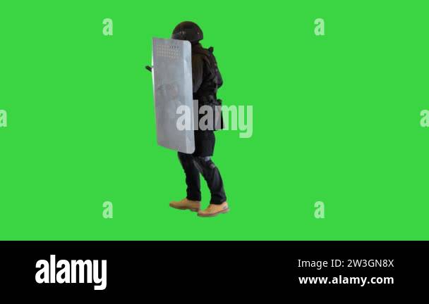 Riot policeman running with a shield and baton on a Green Screen ...