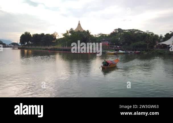 cinematic shot of boats carrying passenger across sarawak river in ...