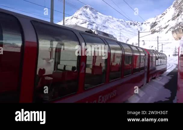 Switzerland Alps , Poschiavo February 2021 - drone view of Bernina Express, red train of Bernina ...