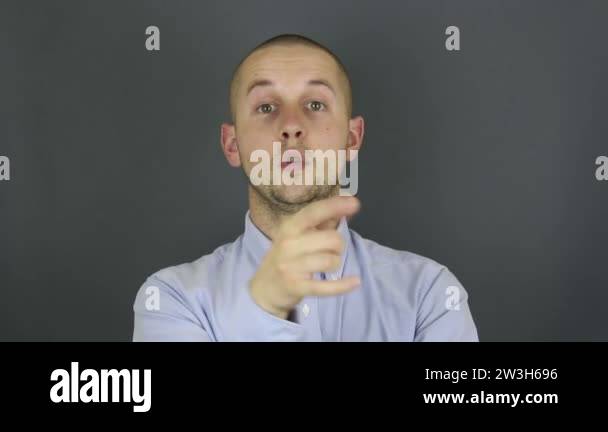 A funny, cute guy asks for a callback and makes a hand gesture ...